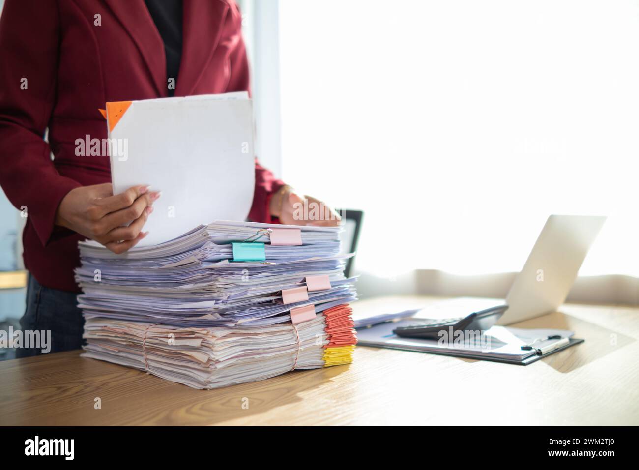 secretary is searching through pile of important documents on office ...
