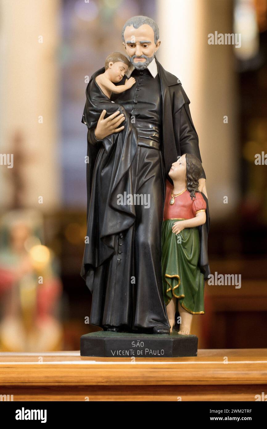 Statue of Saint Vincent de Paul in blurred religious church background ...