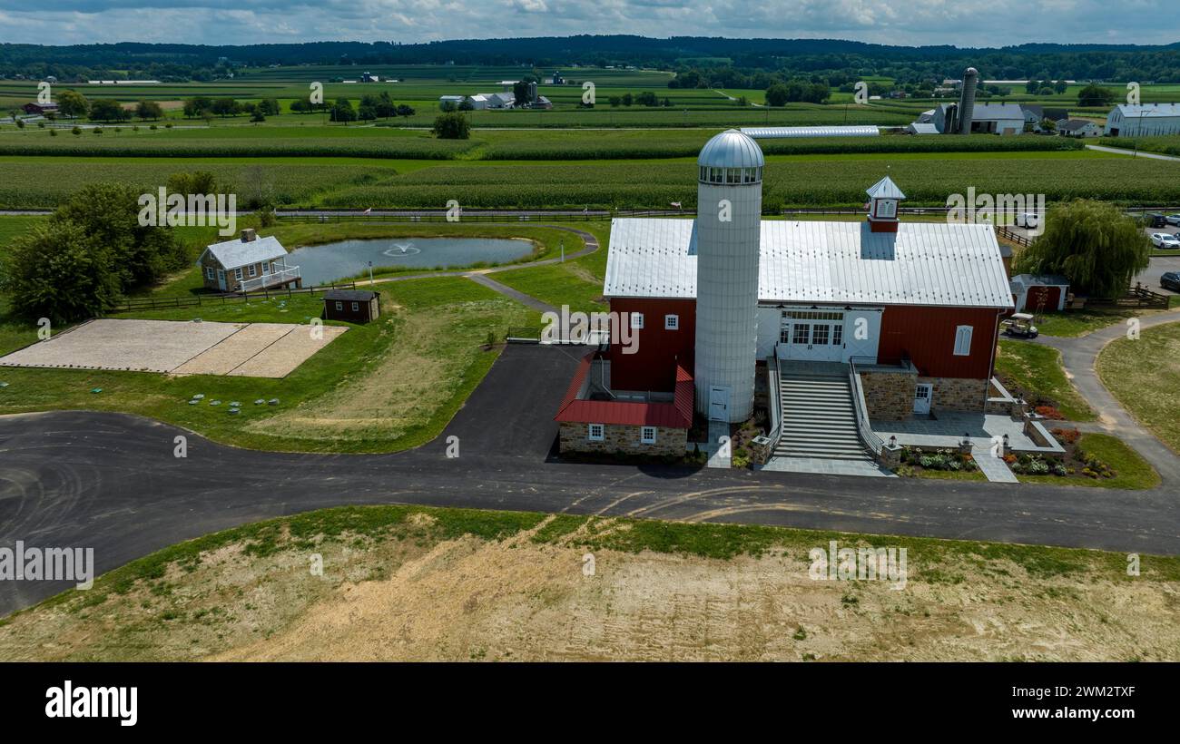 Overlooking A Farmstead Featuring A Majestic Red Barn With Silo, An ...