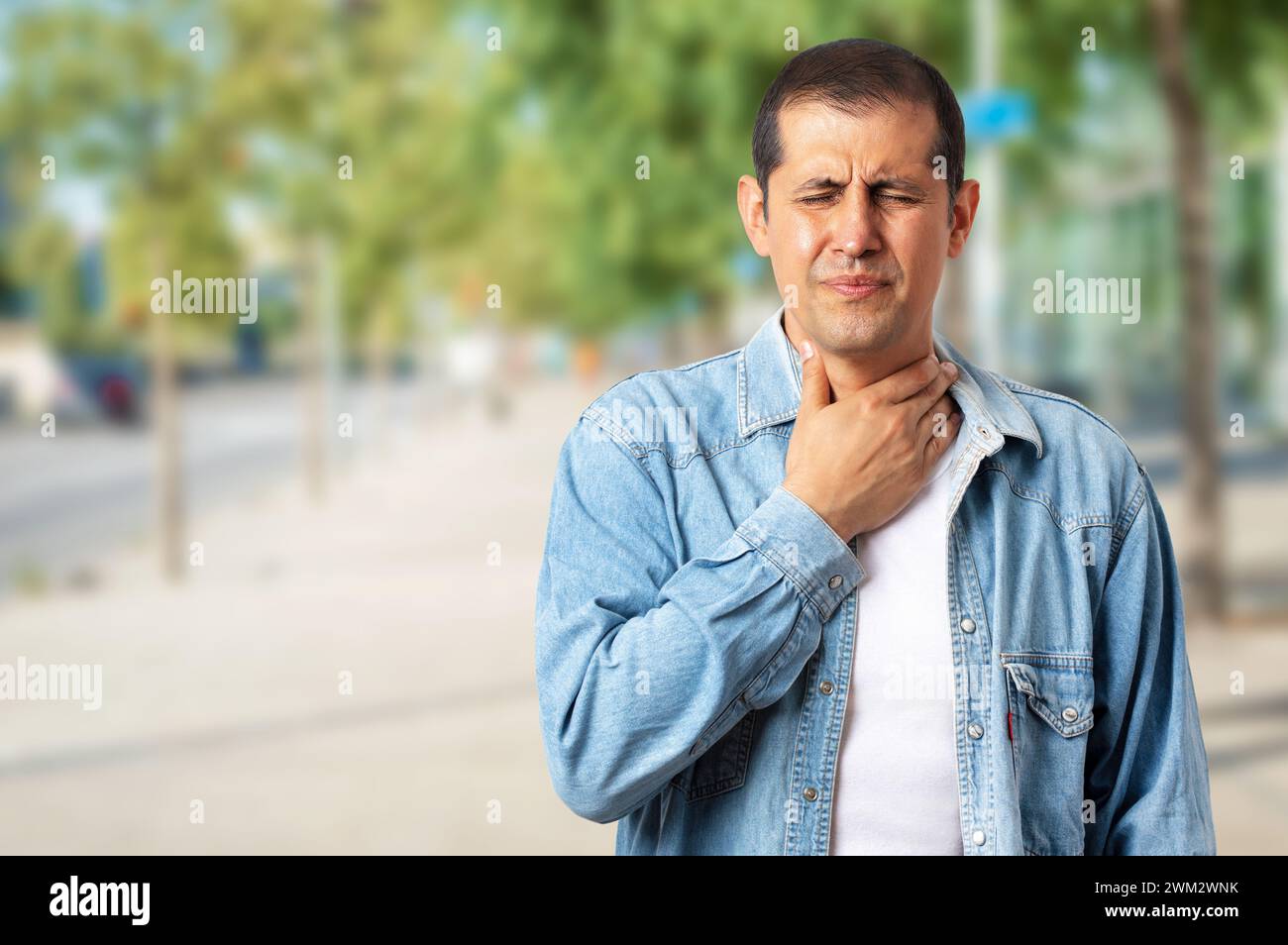 The man feels bad and coughs as a symptom of a cold or bronchitis on ...