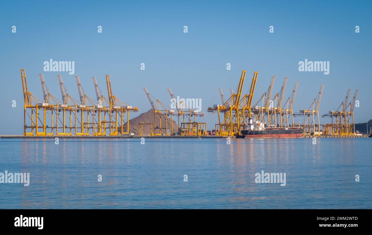 Port cranes loading container ship in the Port of Fujairah, United Arab ...