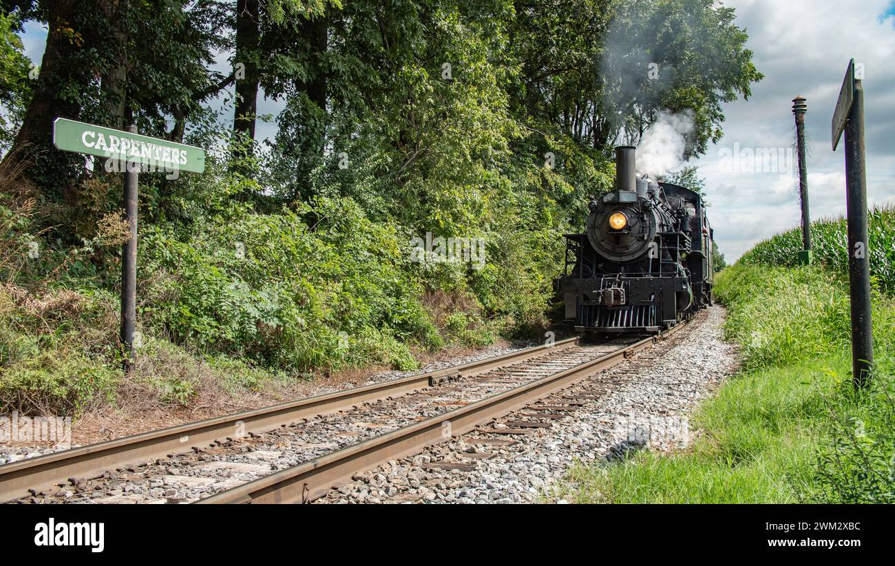 Black Steam Locomotive Number 89 Blowing Steam On Rural Tracks Next To ...