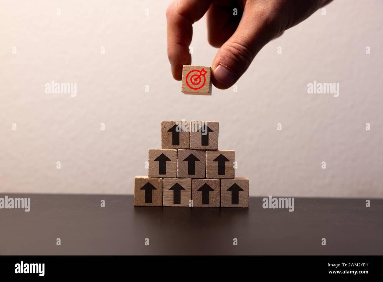 Hand putting print screen dart and target board wooden cube on up ...