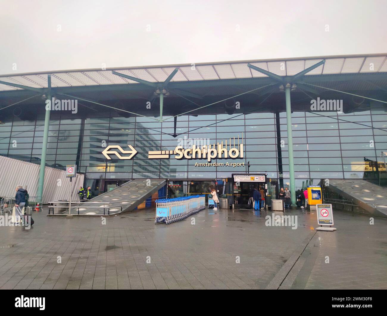 Entrance to the train station and departures hall of Amsterdam Airport ...