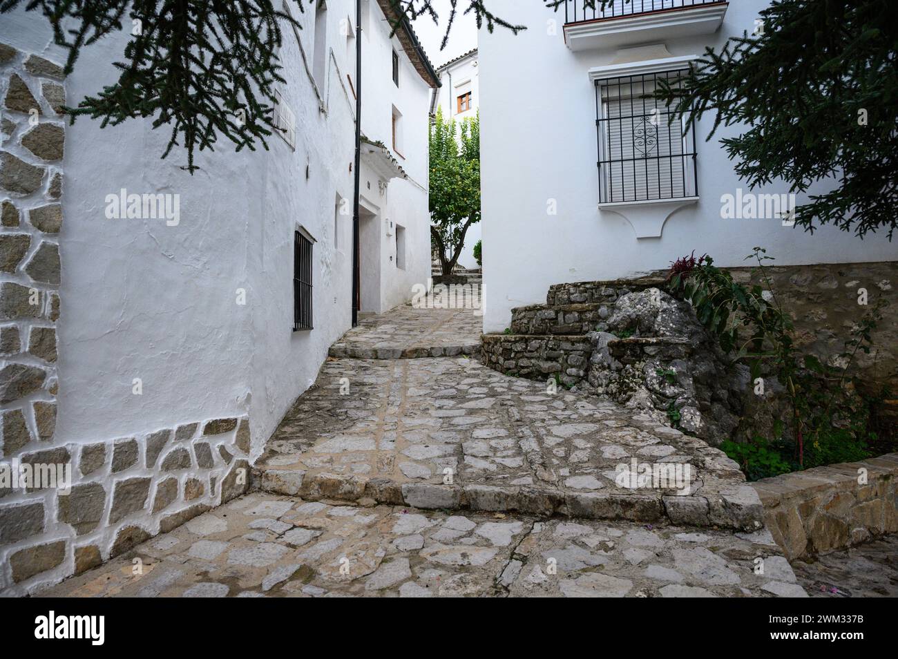 Typical narrow and very pretty streets of an Andalusian village with ...