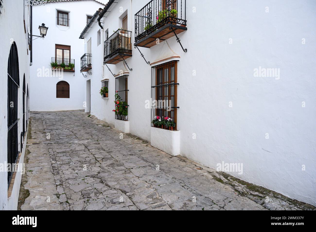 Typical narrow and very pretty streets of an Andalusian village with ...