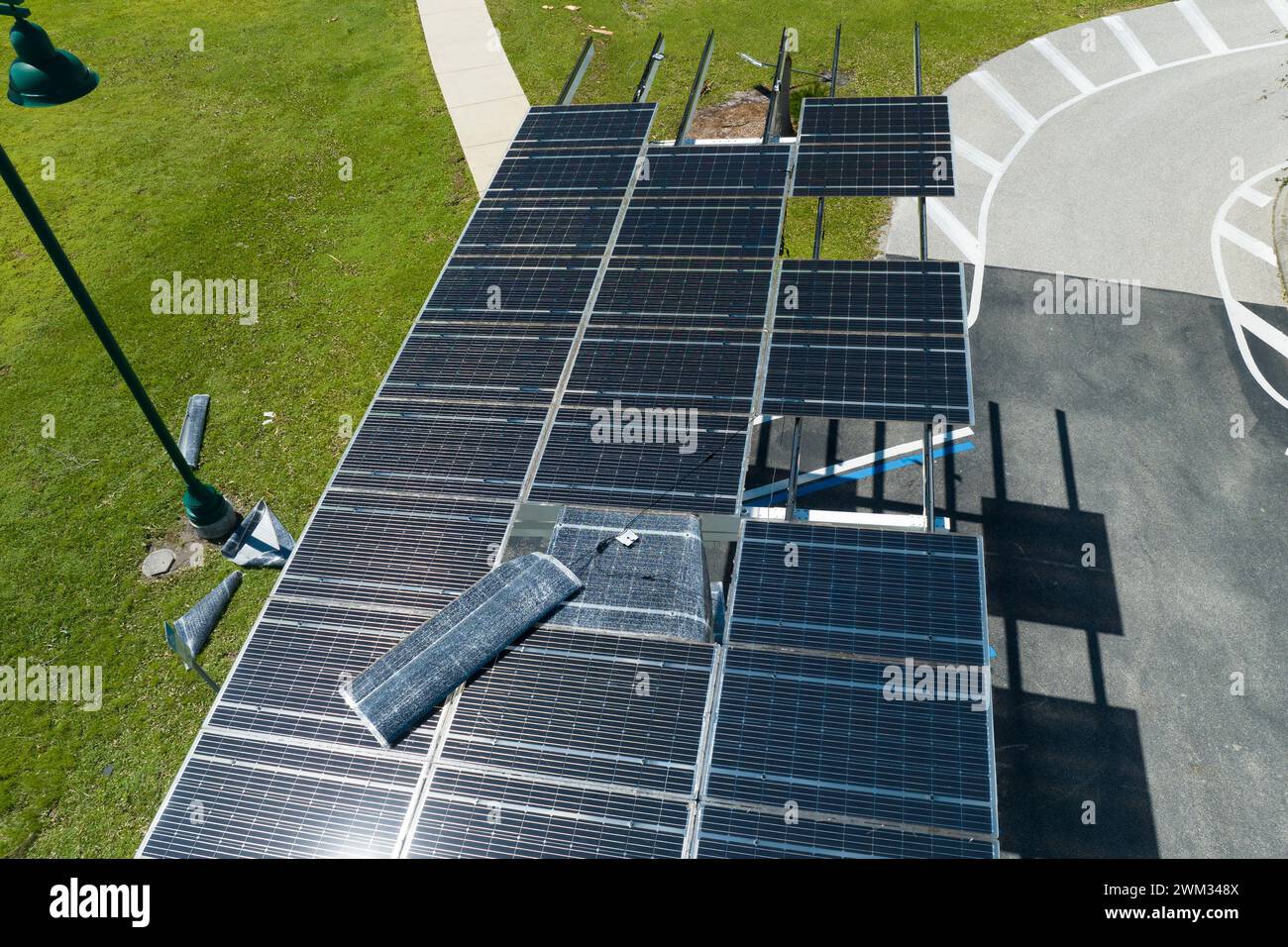 Damaged by hurricane wind photovoltaic solar panels mounted on parking ...