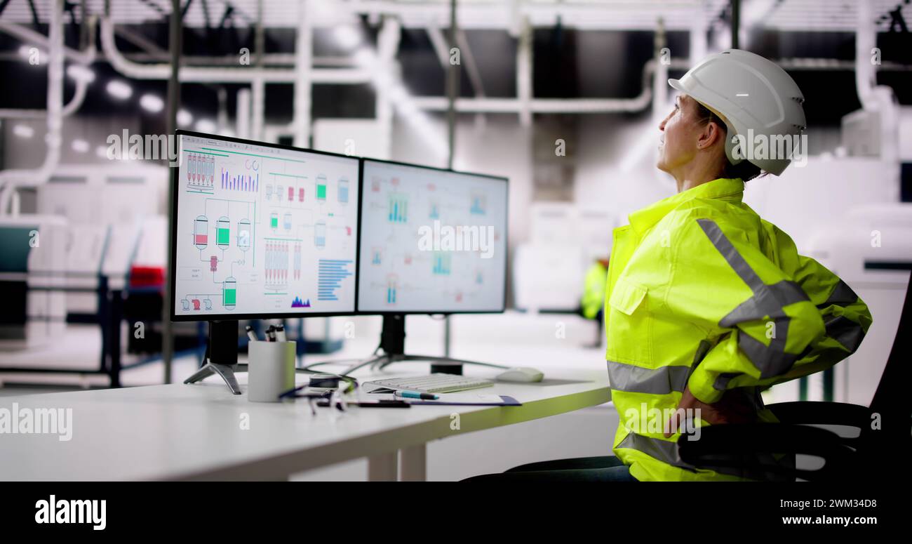 Engineer Operator With Back Pain At Industrial Plant. Bad Posture Stock ...