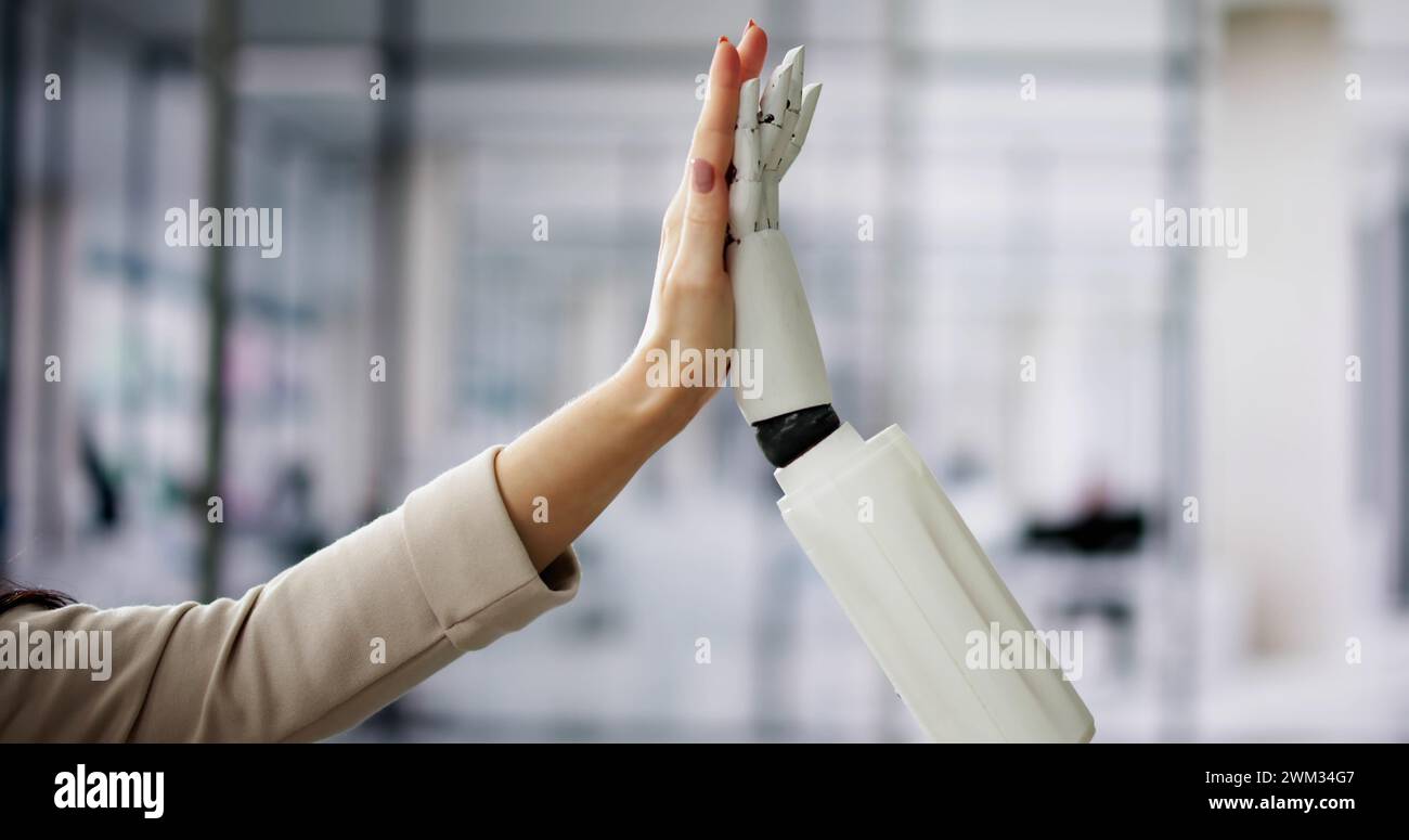 Robot And Woman Giving High Five In Office Stock Photo - Alamy