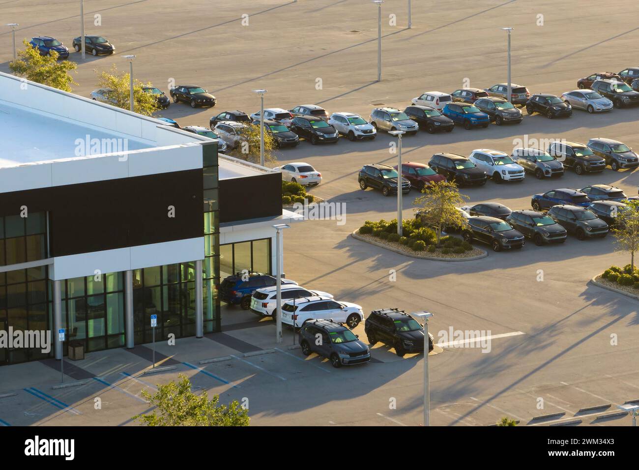 Large parking lot of local dealer with many brand new cars parked for ...