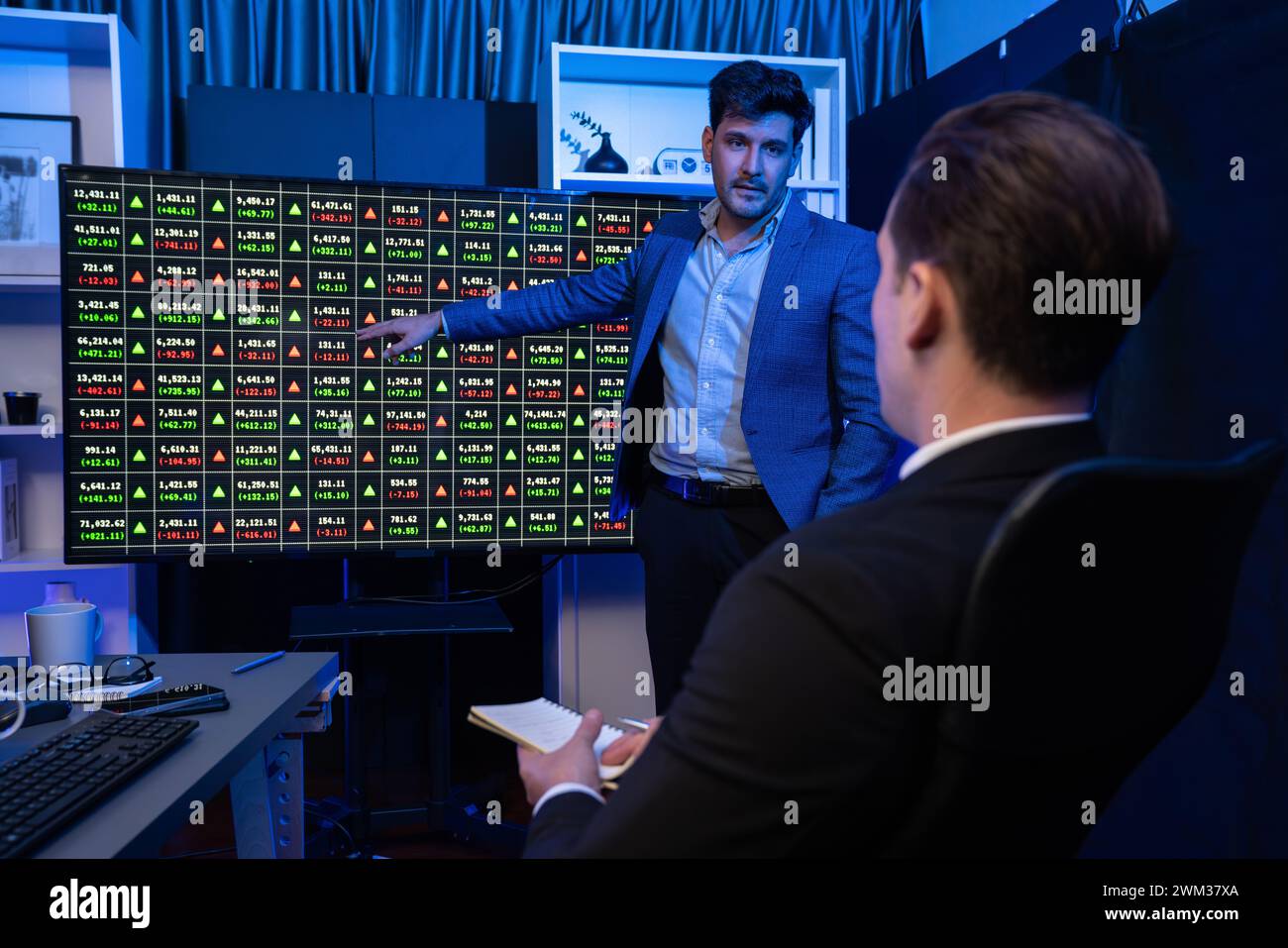 Two stock exchange traders showing dynamic valued investment low and ...