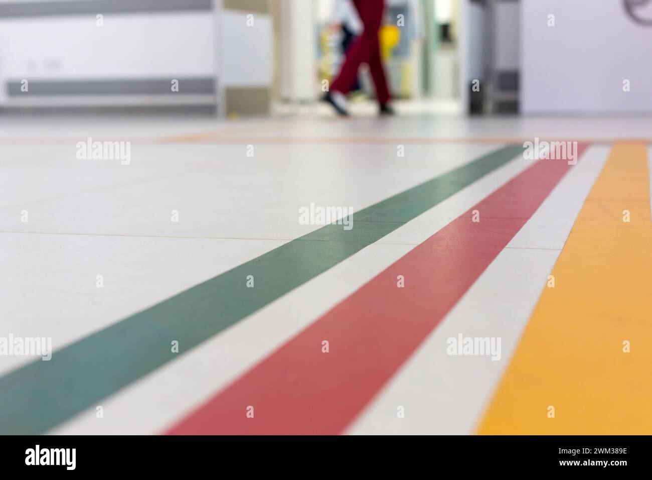 Colorful guide lines on the floor of the hospital corridor for ...