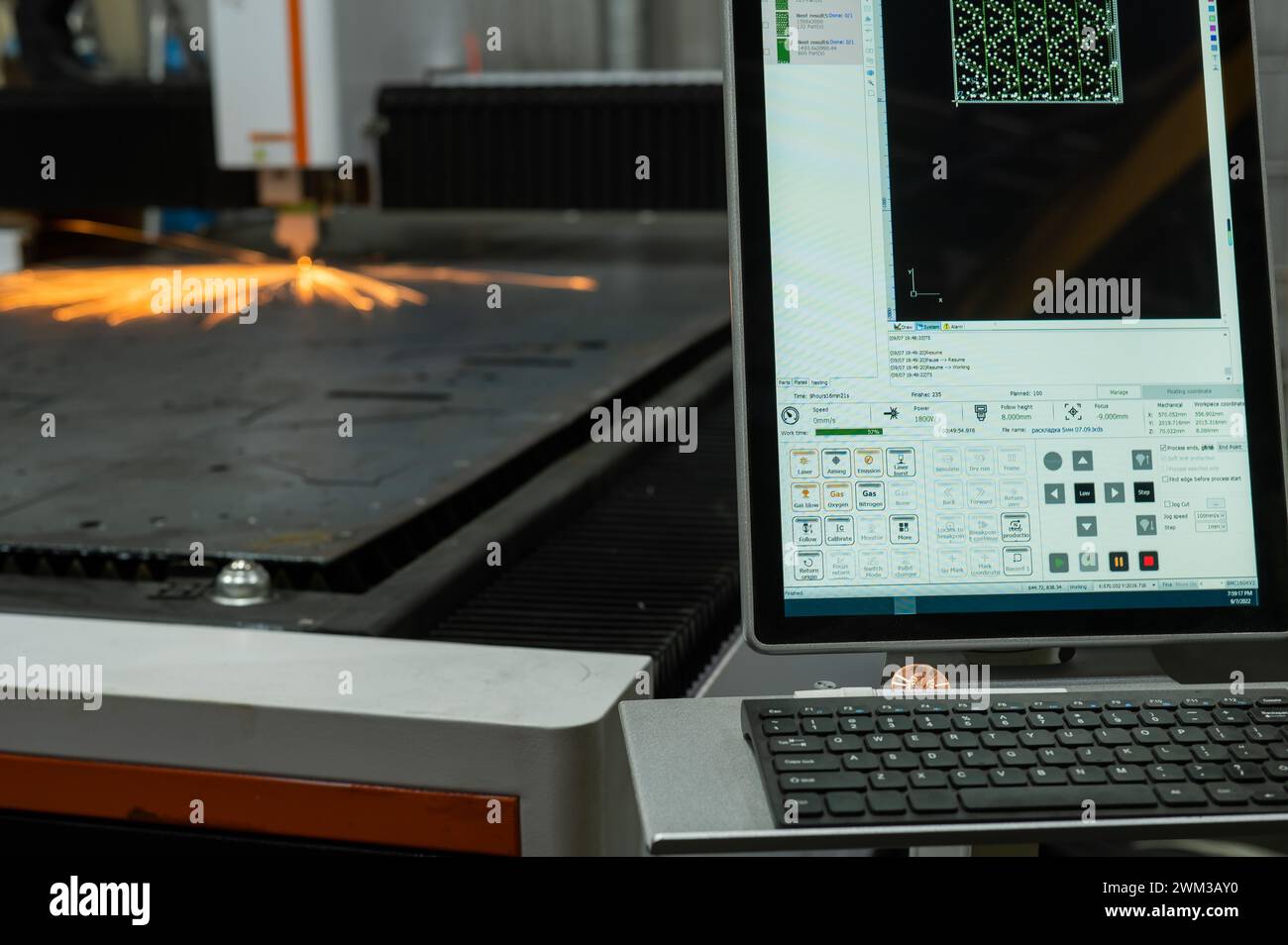 CNC machine. Laser cutting of metal. Sparks Stock Photo - Alamy