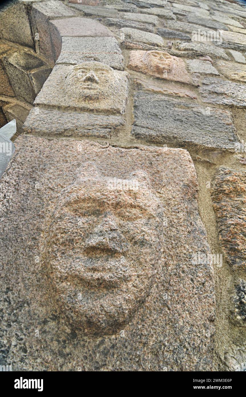Engravings and bas-reliefs depicting grotesque human and devil masks on ...