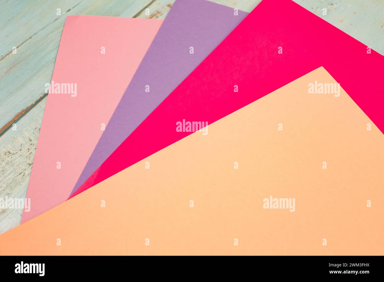 sheets of colored paper. Many colored sheets of paper are laid out in ...