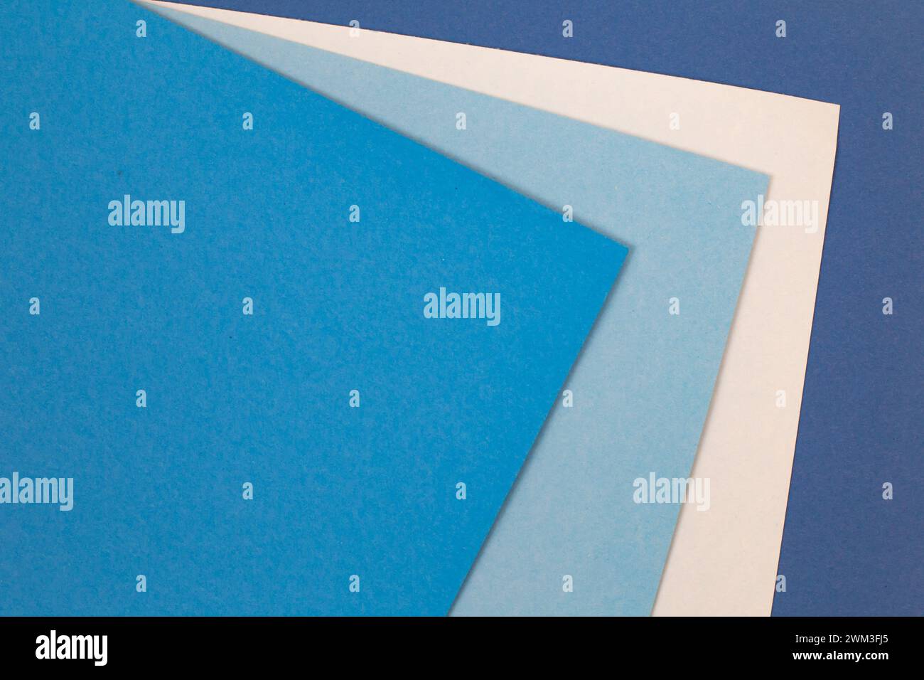 sheets of colored paper. Many colored sheets of paper are laid out in ...