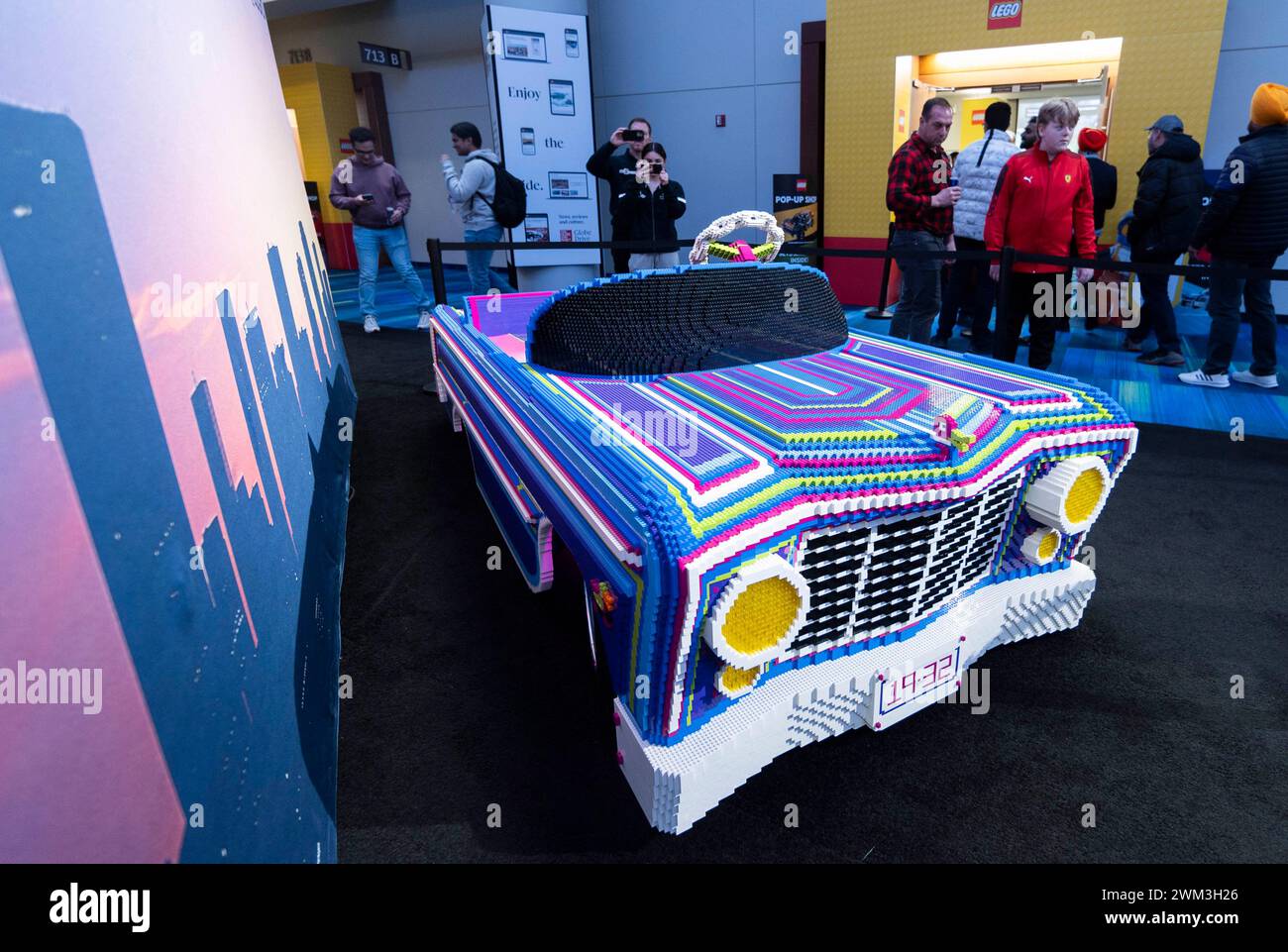 Toronto, Canada. 23rd Feb, 2024. People look at a LEGO car at the 2024 Canadian International ...