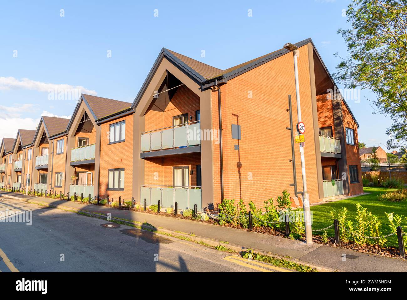 New low-rise brick apartment building along a street at sunset Stock ...
