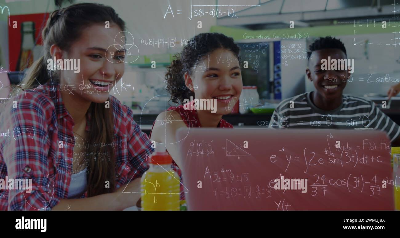 Image of mathematical equations over school children using laptop in ...