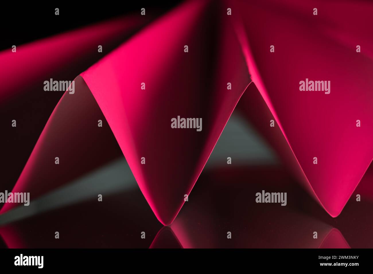 Perspective abstract image of paper folded in a pleated pattern with ...
