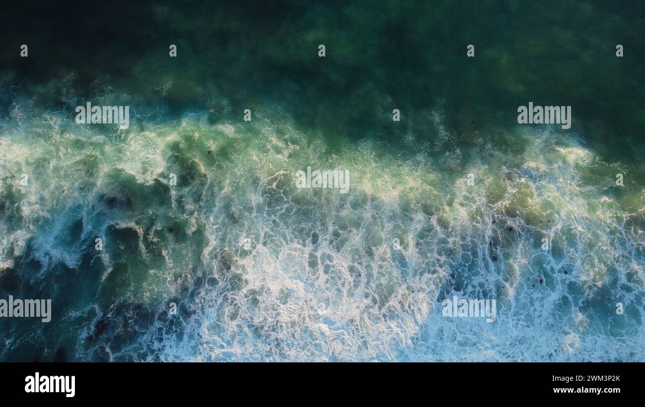 Aerial view of waves breaking on the shore Stock Photo - Alamy