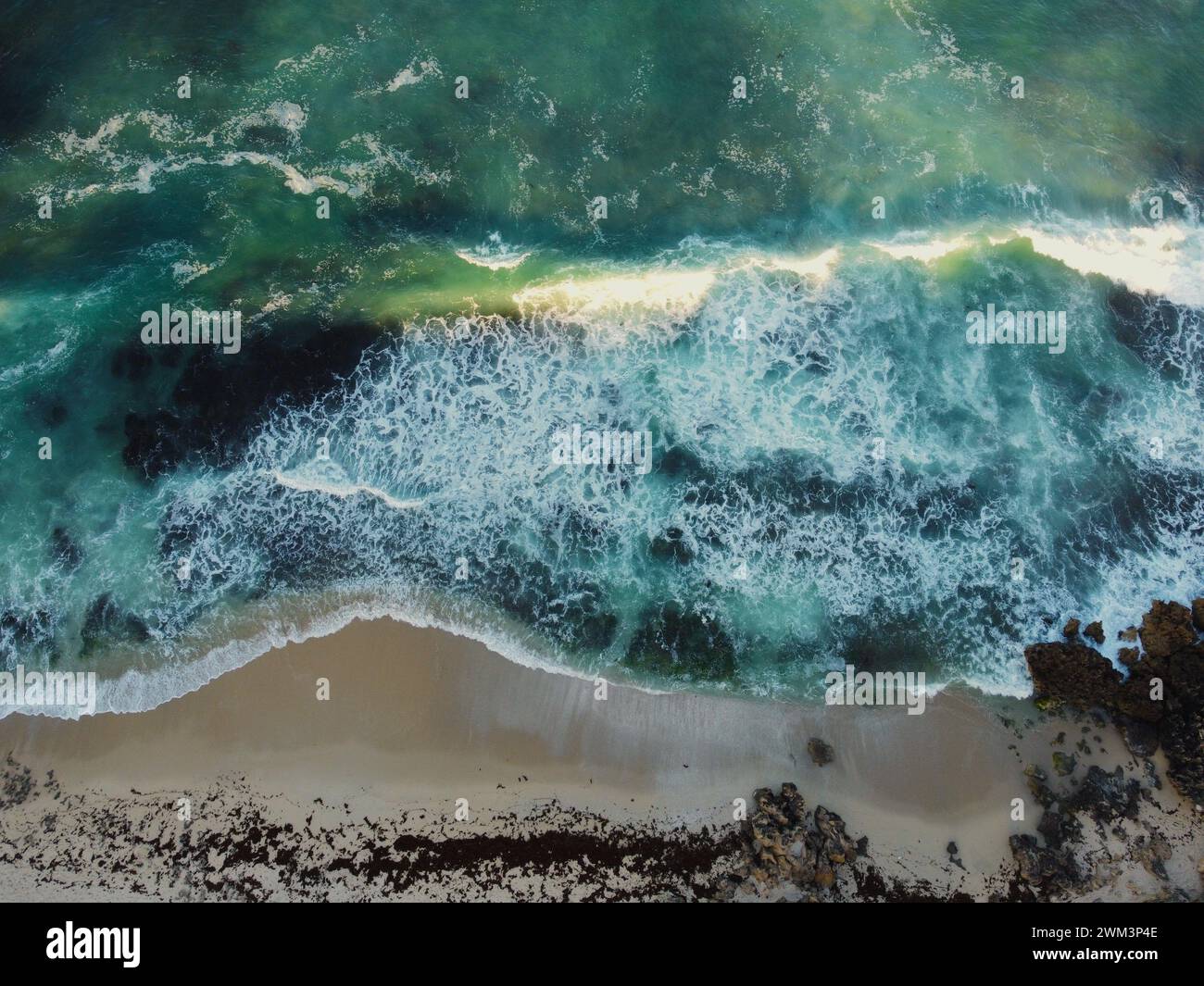Aerial view of waves breaking on a beach Stock Photo - Alamy