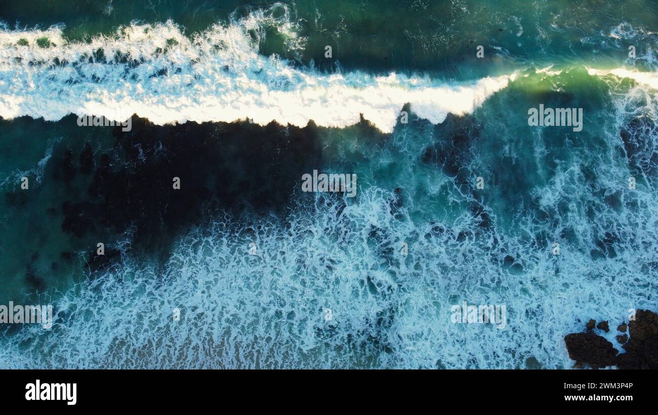 Aerial view of waves rolling towards the shore Stock Photo - Alamy