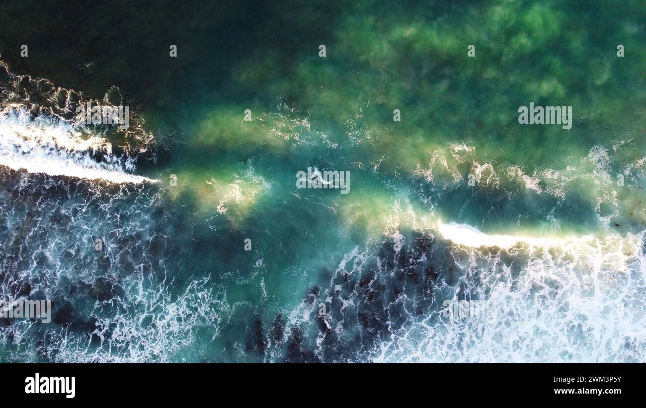 Aerial view of waves rolling towards the shore Stock Photo - Alamy