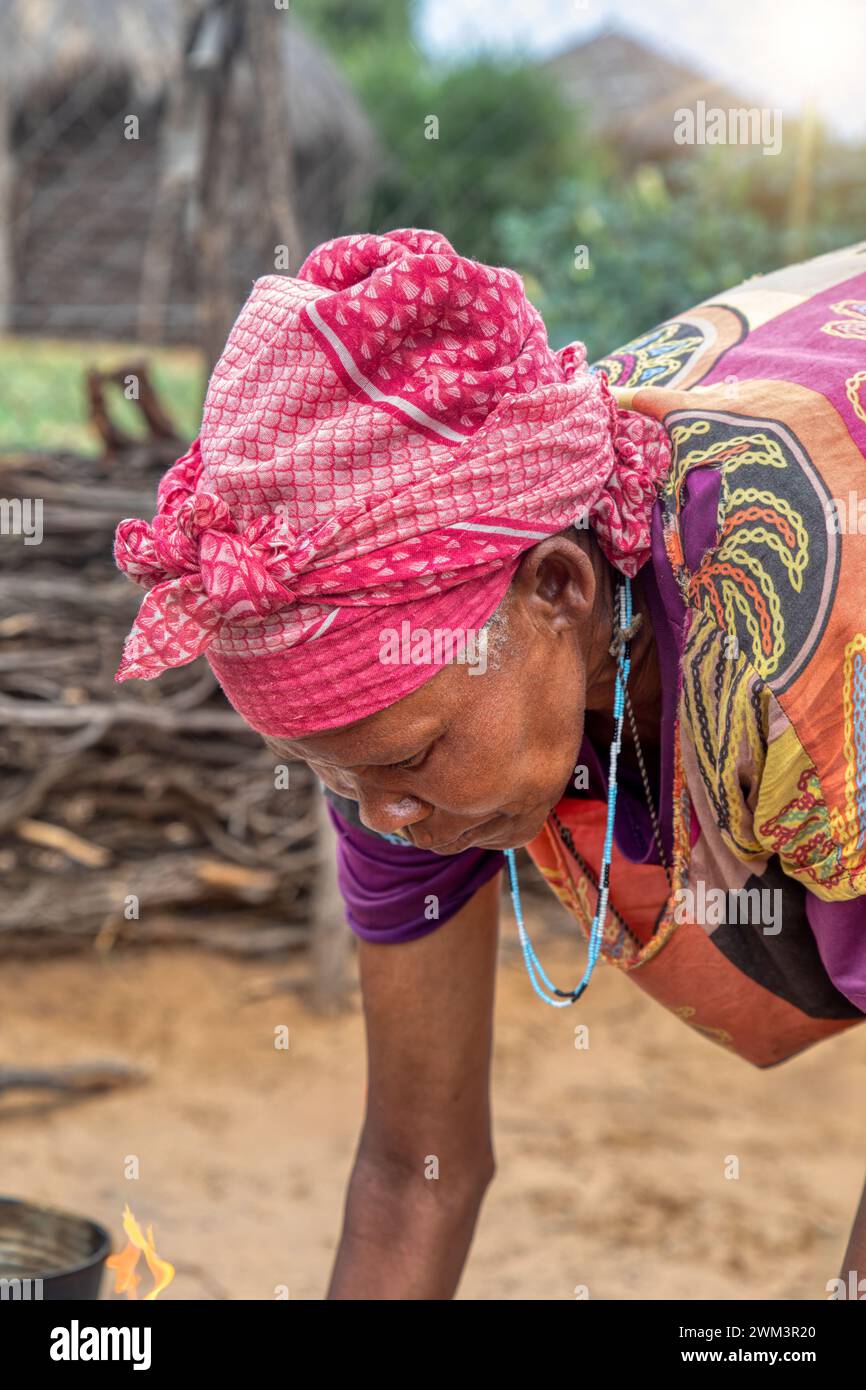 portrait of an old african village woman in the outdoors kitchen ...