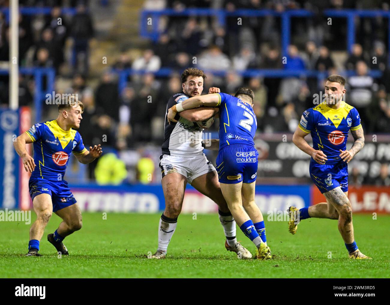 Nick Staveley Hull FC is tackled by Josh Thewlis of Warrington Wolves ...