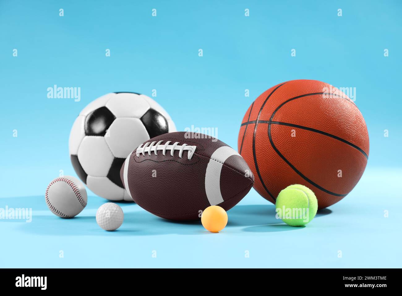 Many different sports balls on light blue background Stock Photo - Alamy