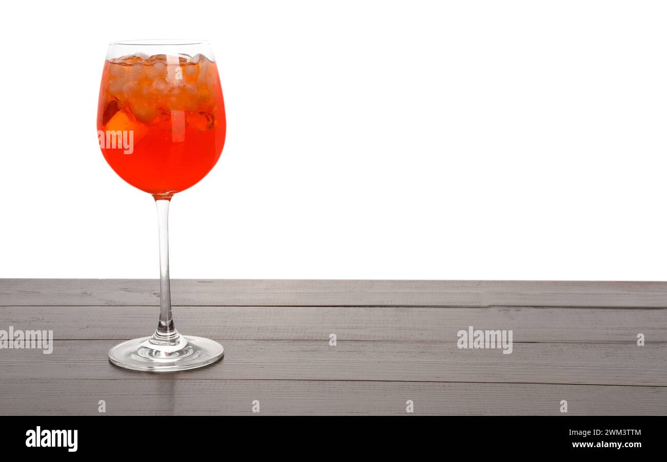 Aperol spritz cocktail and ice cubes in glass on wooden table against ...