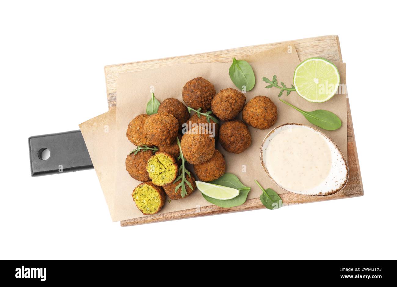 Delicious falafel balls, sauce, herbs and lime isolated on white, top ...