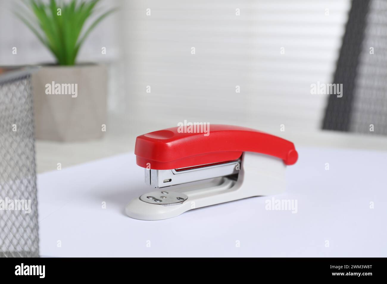Bright stapler and paper on table indoors, closeup Stock Photo - Alamy
