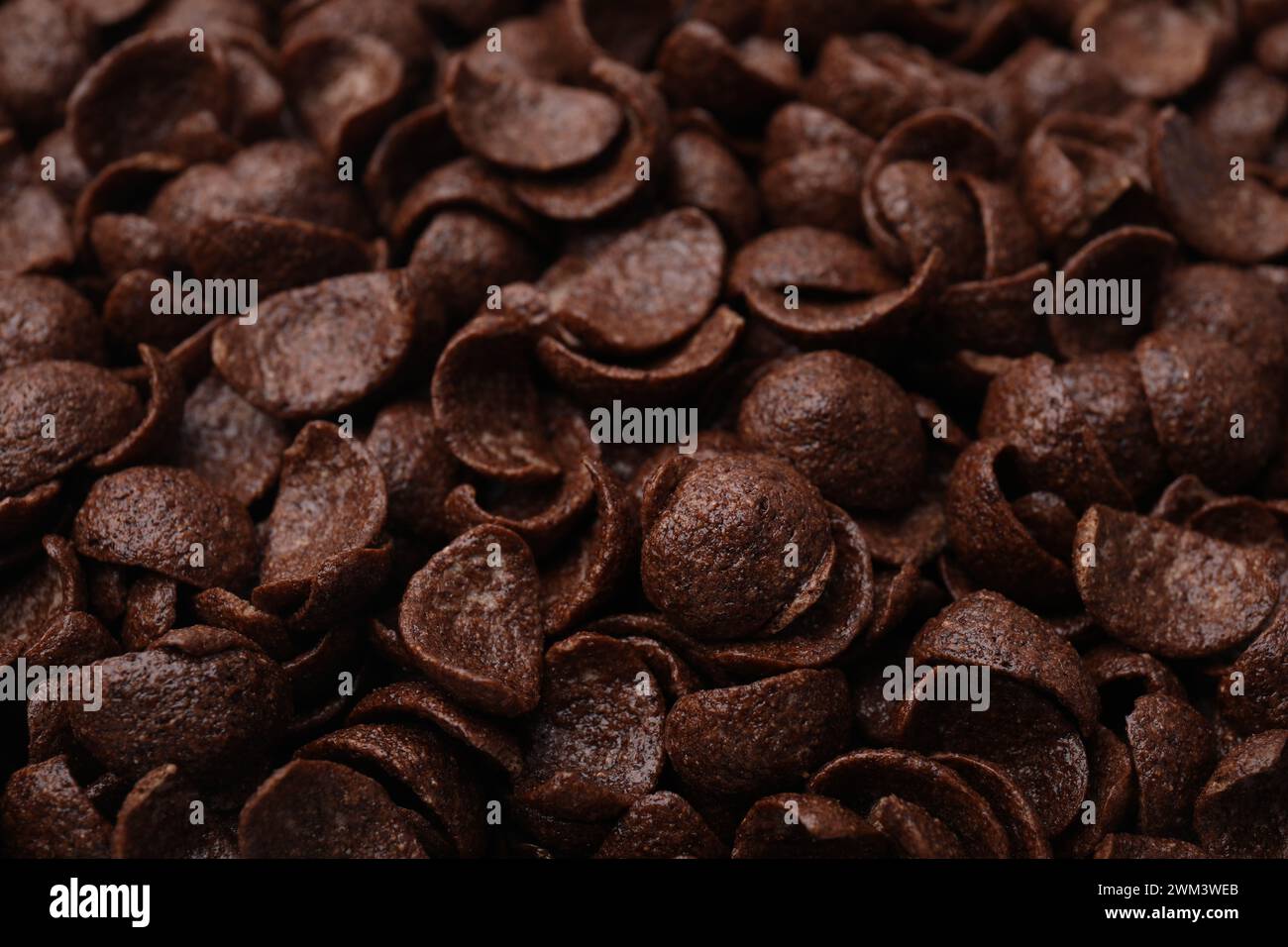 Breakfast cereal. Tasty chocolate corn flakes as background, closeup ...
