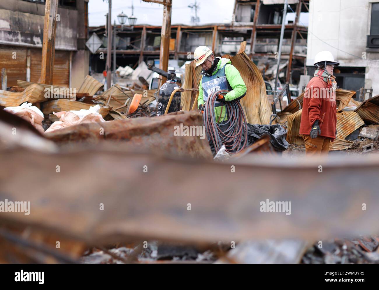 Volunteers remove debris at a disaster-stricken area in Wajima City ...