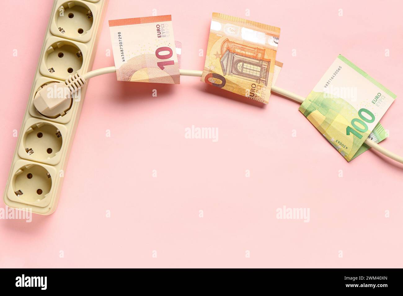 Plug with euro banknotes and power socket on pink background ...