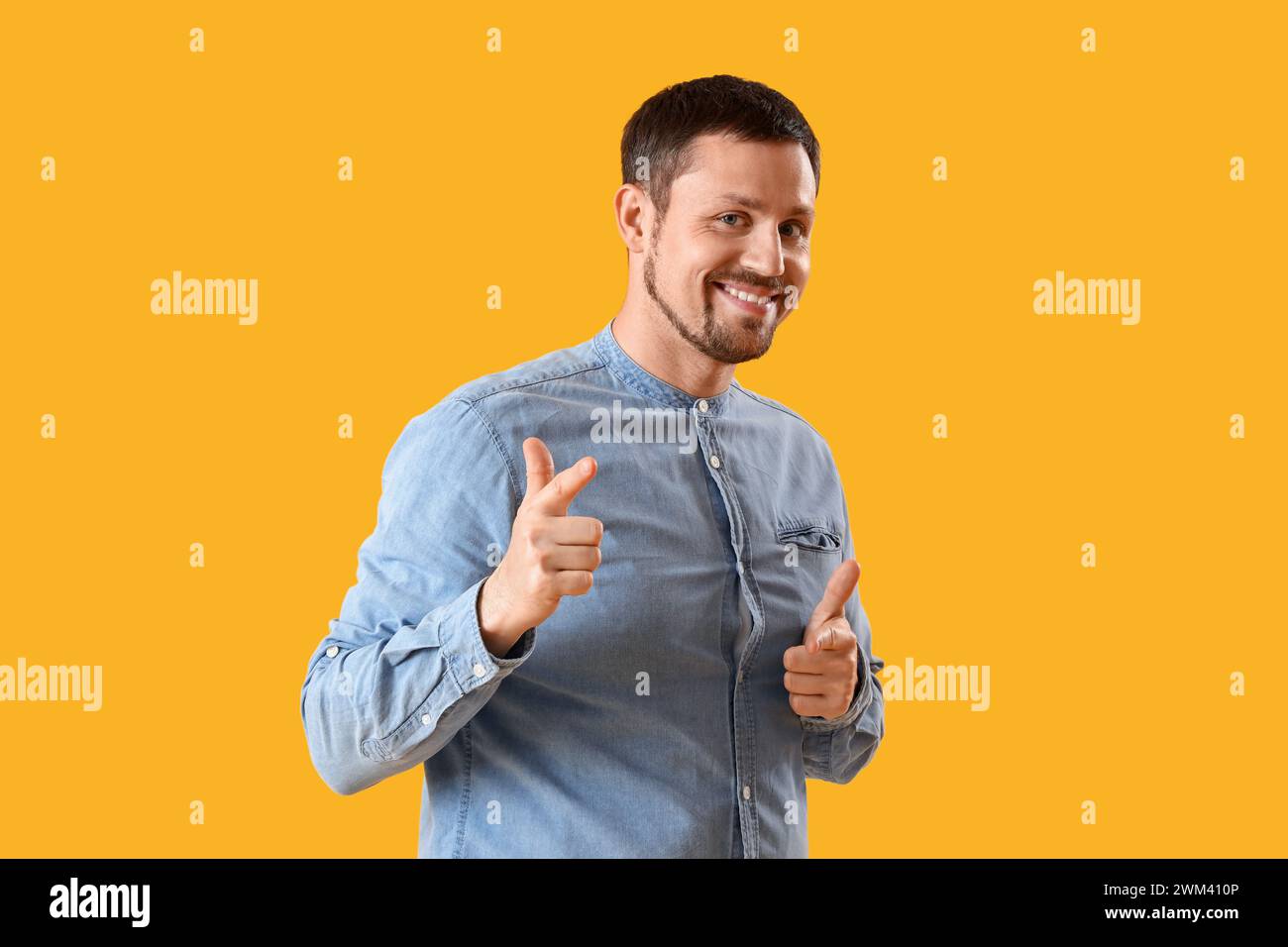 Positive young man pointing viewer hi-res stock photography and images ...
