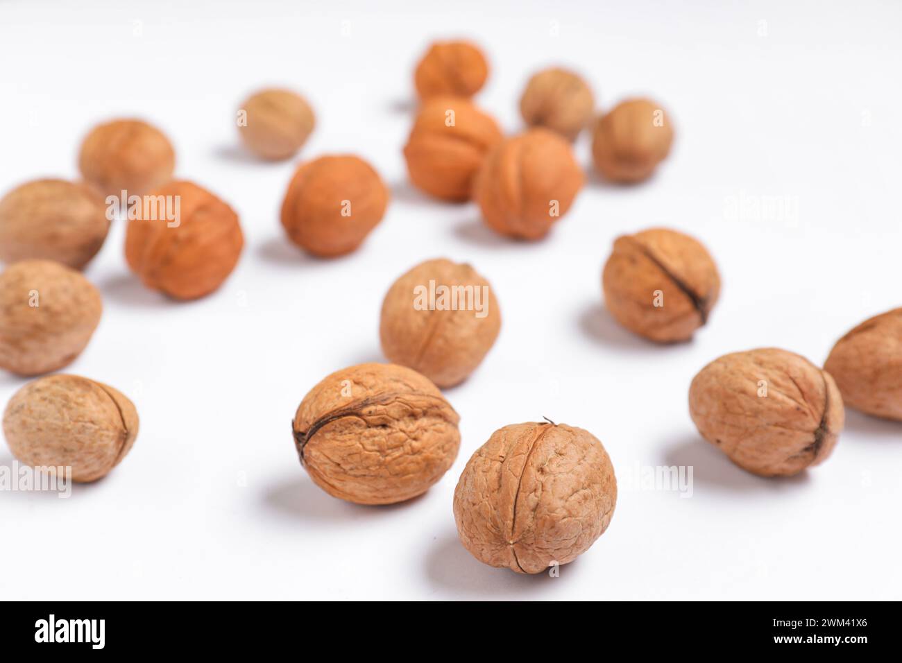 Whole walnuts on white background Stock Photo - Alamy