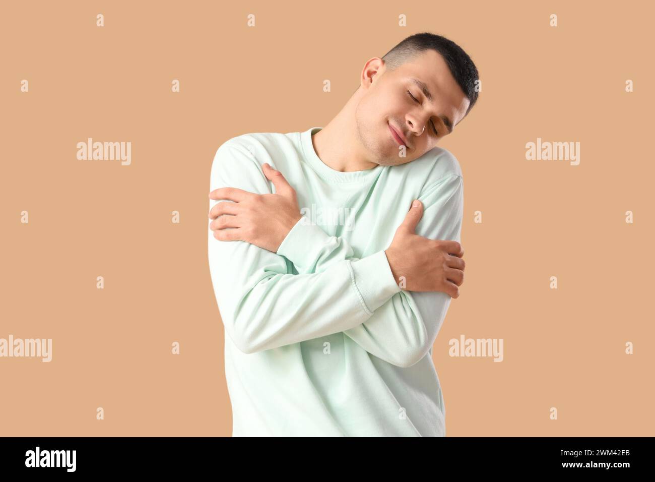 Guy hugging himself hi-res stock photography and images - Alamy