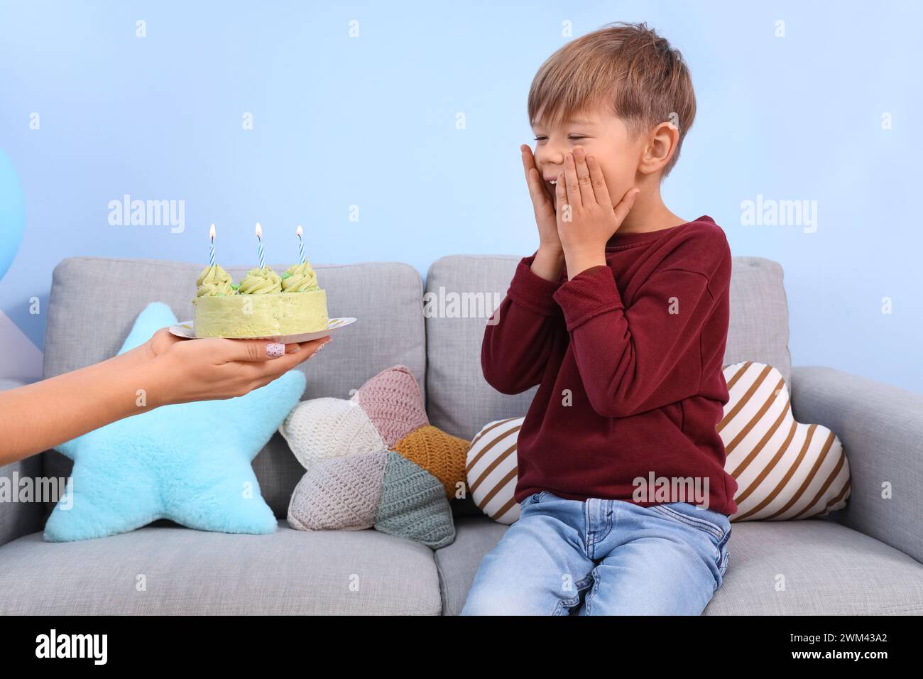 Surprised little boy receiving Birthday cake at home Stock Photo - Alamy