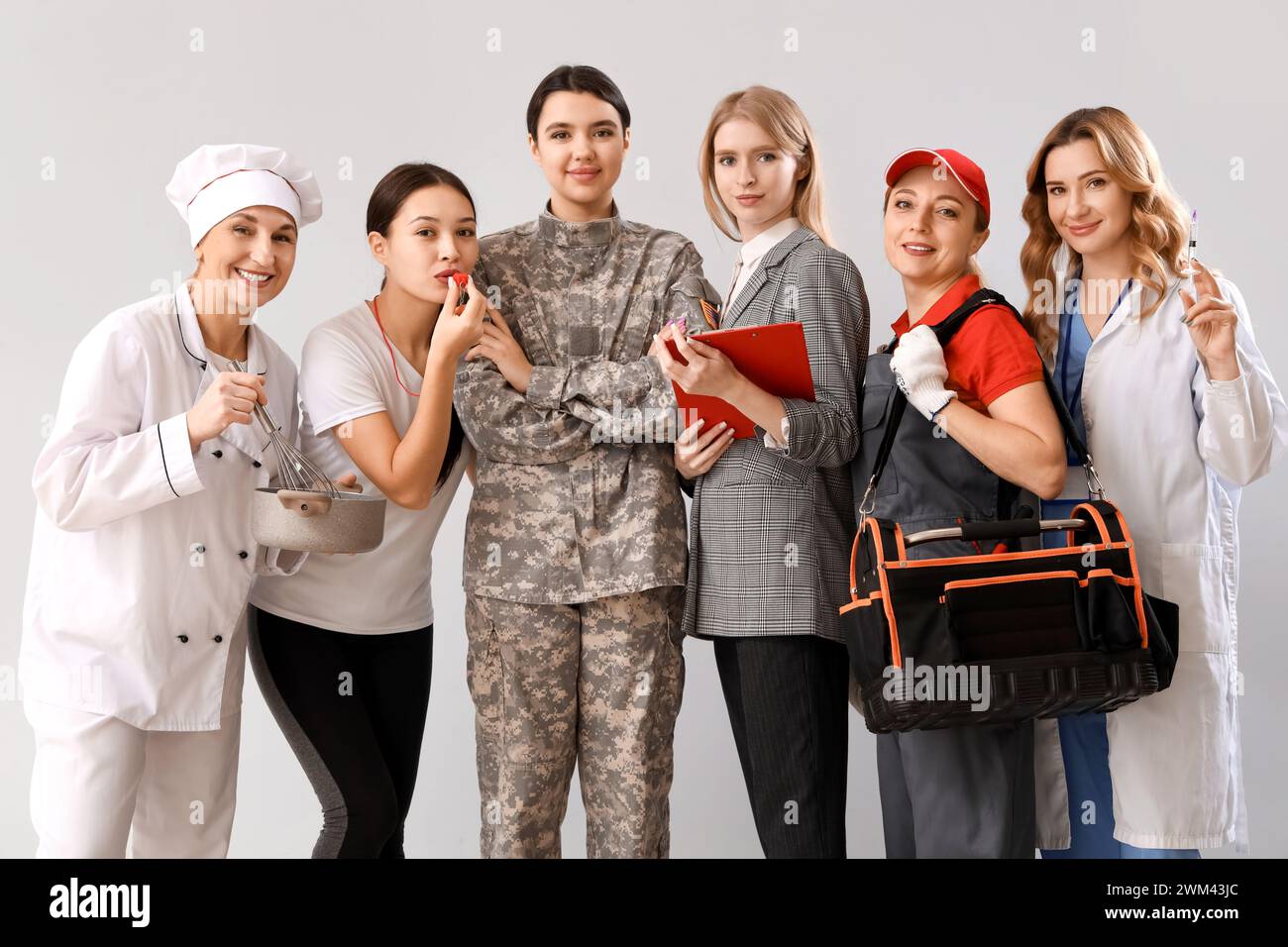 Women of different professions on grey background Stock Photo - Alamy