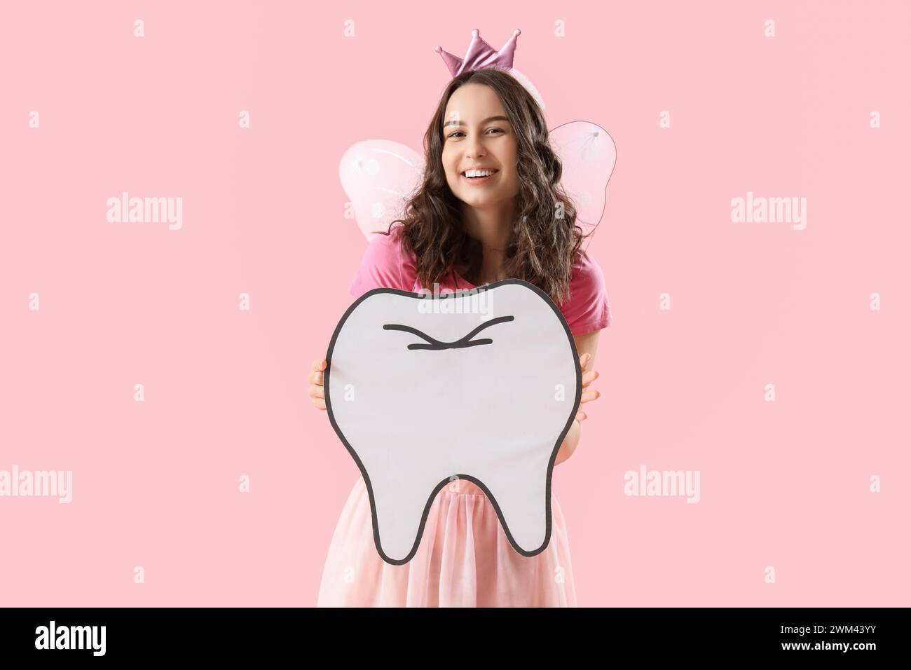 Tooth Fairy with paper figure on pink background Stock Photo - Alamy