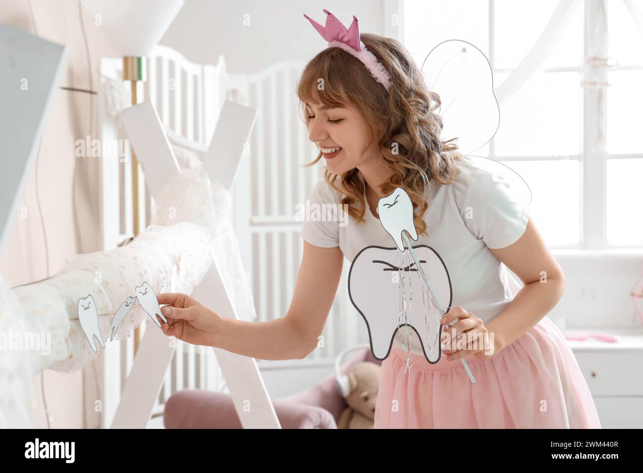 Tooth Fairy with wand and paper teeth in children's bedroom Stock Photo ...