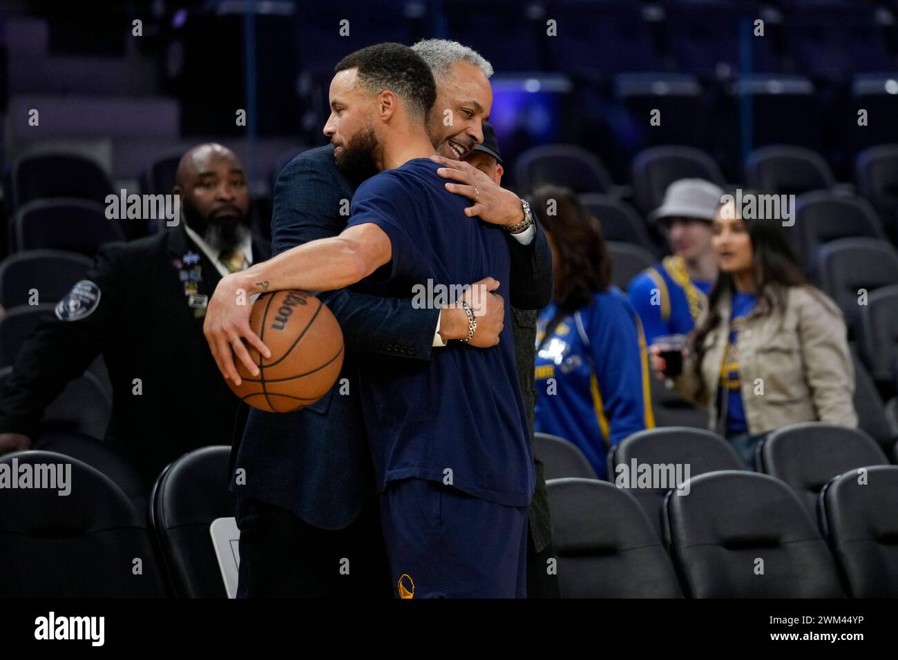 Golden State Warriors guard Stephen Curry, right, is hugged by his ...