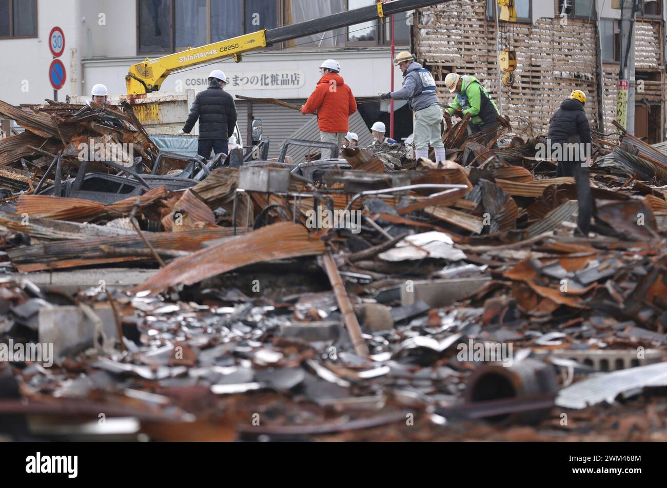 Volunteers remove debris at a disaster-stricken area in Wajima City ...