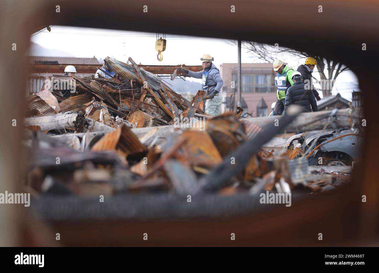 Volunteers remove debris at a disaster-stricken area in Wajima City ...