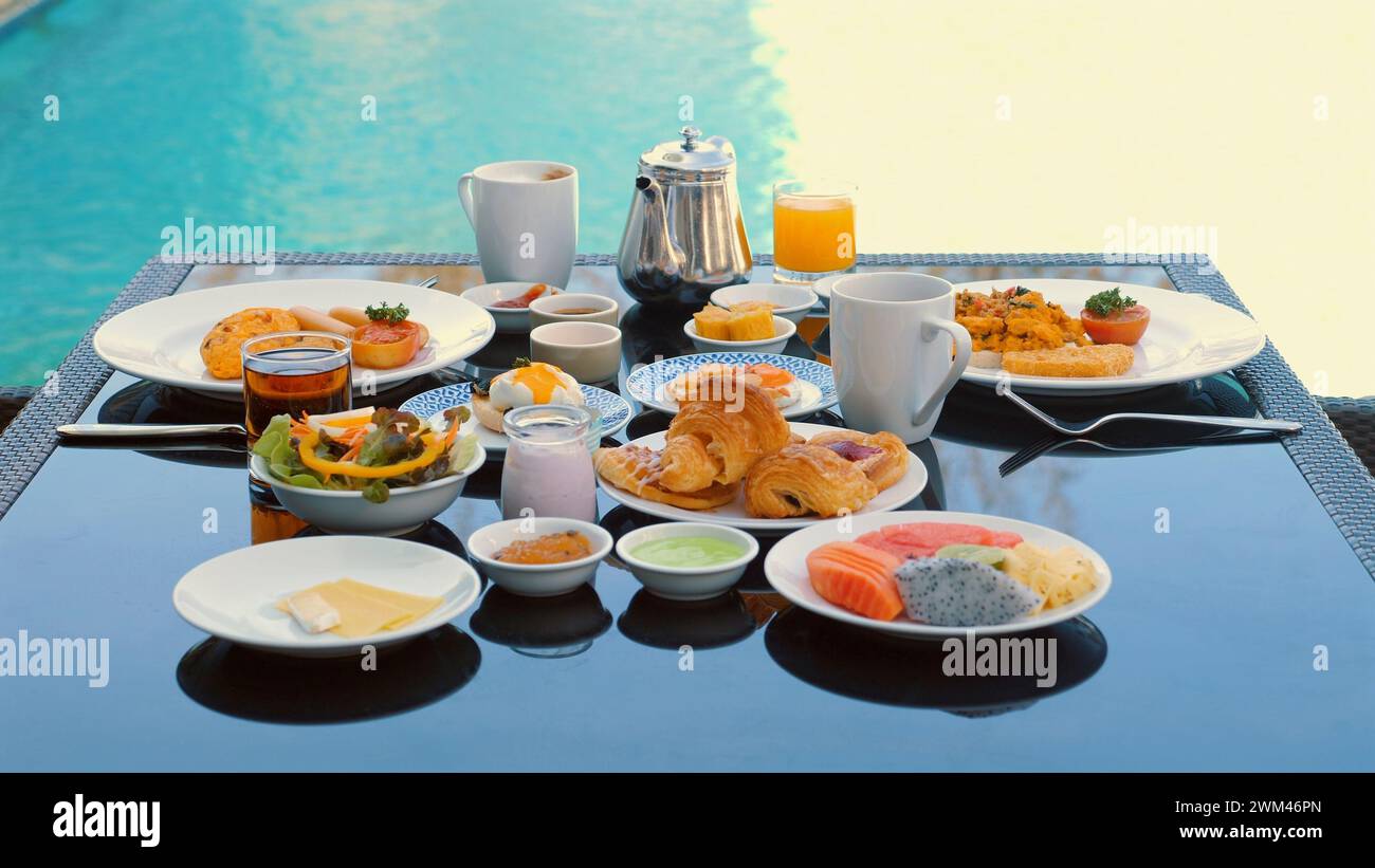 Sumptuous breakfast buffet spread overlooking tranquil pool Stock Photo ...