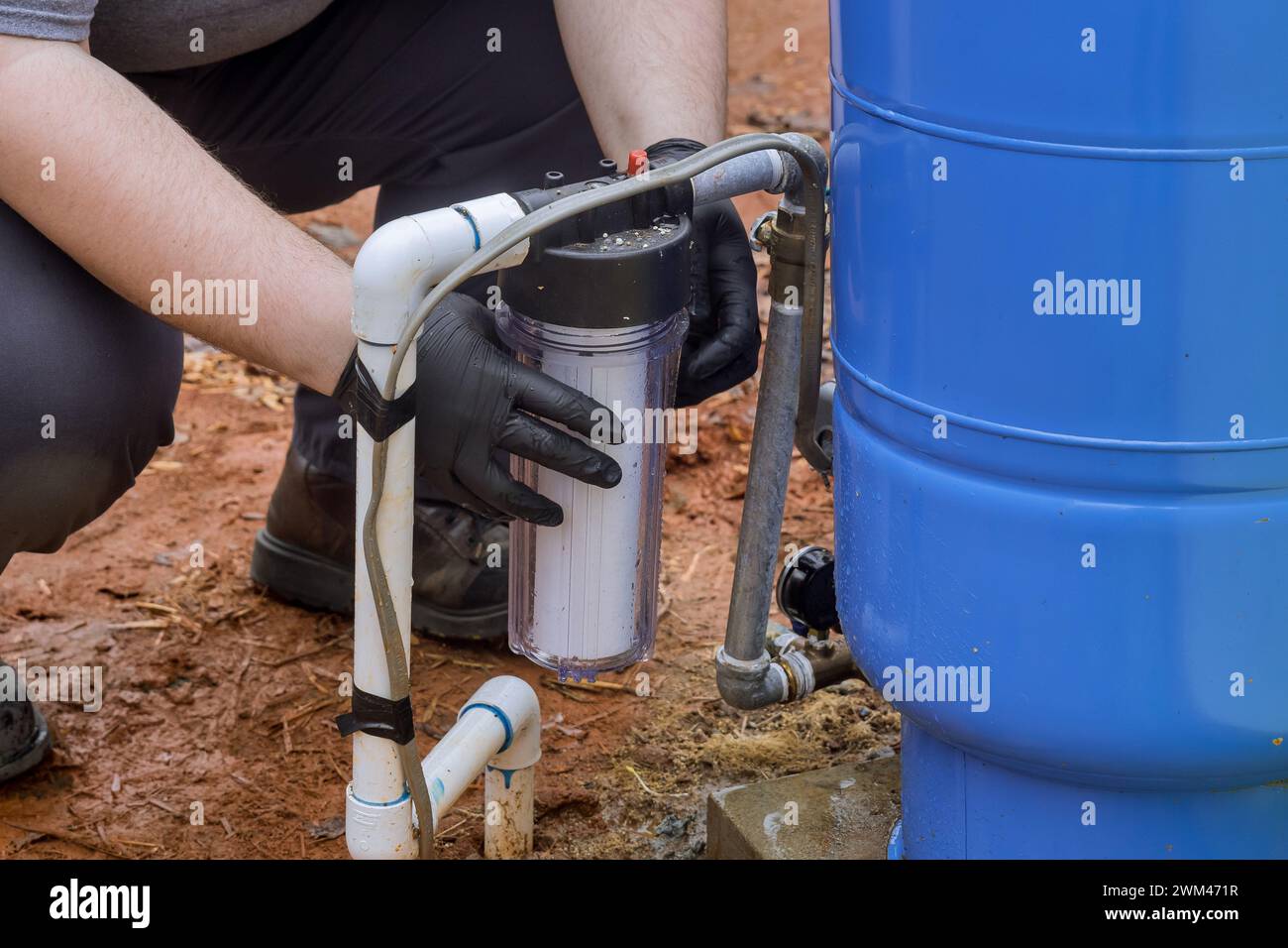 An installation of water purification filter cartridge is being ...
