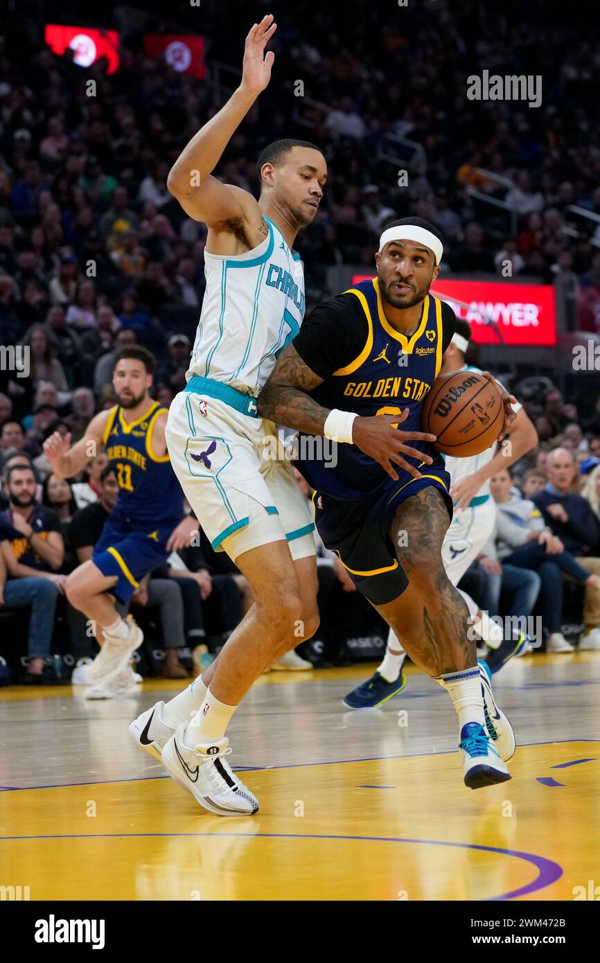 Golden State Warriors guard Gary Payton II drives against Charlotte Hornets guard Bryce McGowens ...